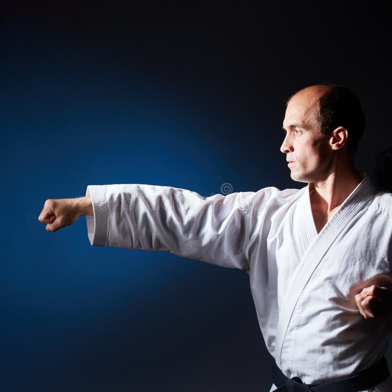 On a Blue Background a Young Athlete Makes a Punch Arms Stock Photo ...