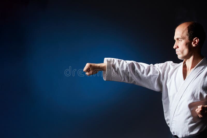 On a Blue Background, a Young Athlete Performs a Punch Arm Stock Image ...