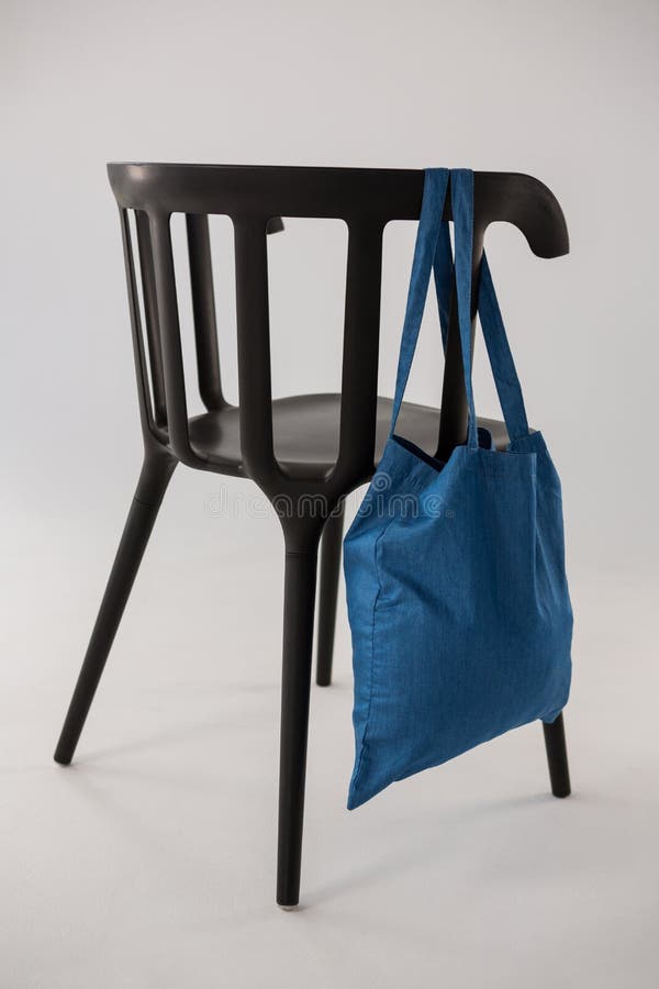 Blue Bag Hanging on a Black Chair Stock Photo - Image of sale, chair ...