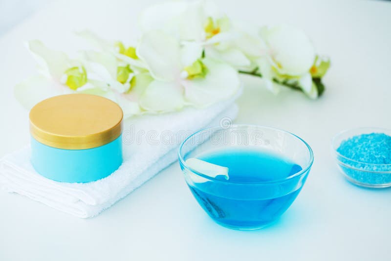 Blue Bath Salt, Body Cream and Shells for Spa on White Table Background ...