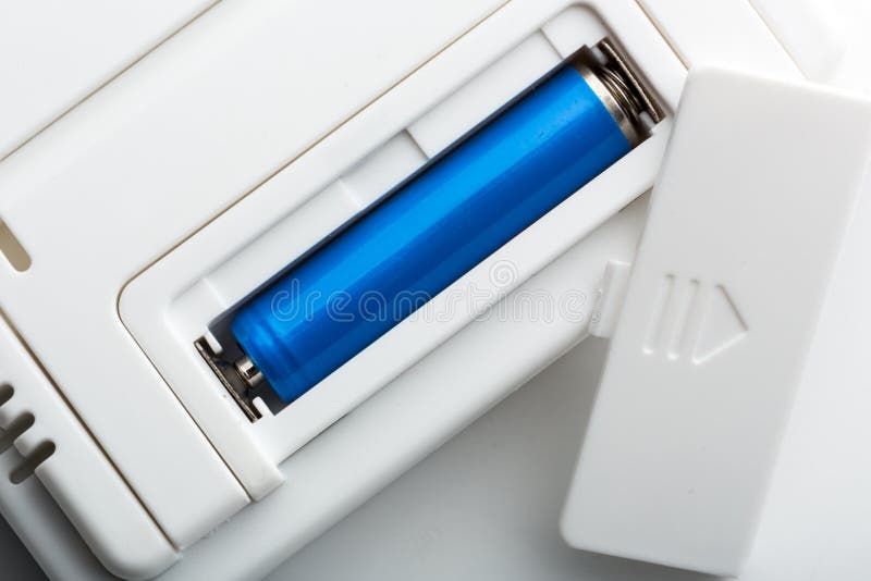 Blue battery in the socket stock image. Image of rear - 49067163