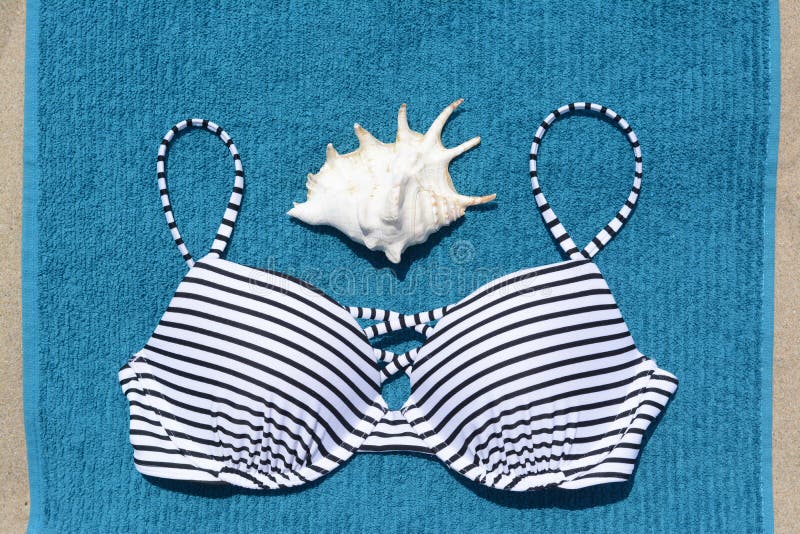 Blue Beach Towel, Seashell and Swimsuit on Sand, Top View Stock Photo ...