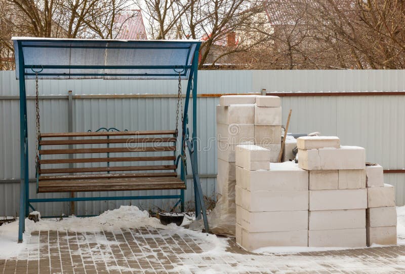 A Blue Bench is Next To a Pile of White Bricks Stock Photo - Image of ...