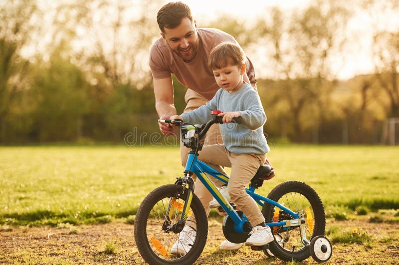 Blue Bicycle, Riding. Happy Father with Son are Having Fun on the Field ...