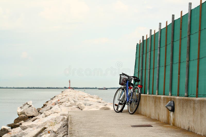 Blue Bike Parked by Rock Path Leading into the Sea Stock Image - Image ...