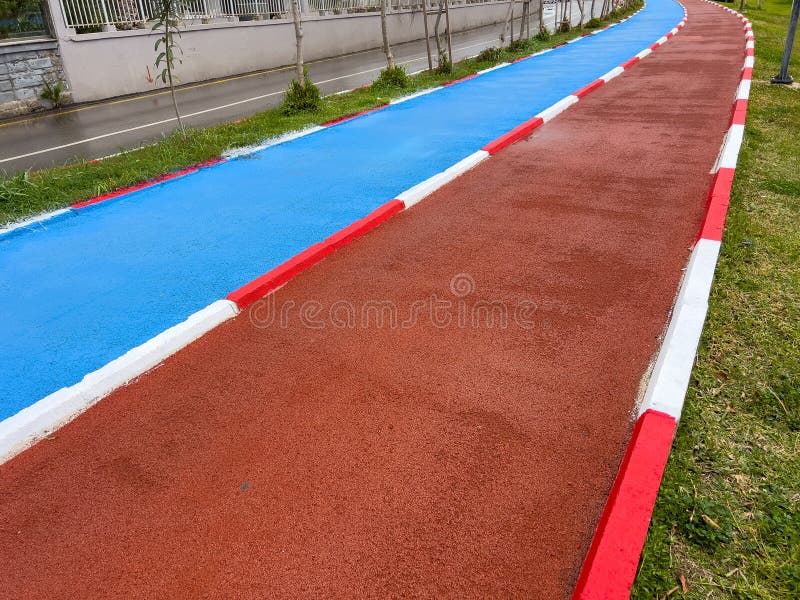 Blue Bike Path and Red Running Path Run Side by Side through a Public ...