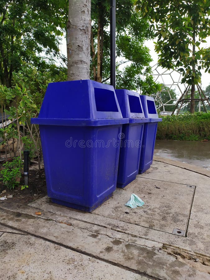 Beside the Blue Bin is a Mask Placed Next To it Stock Photo - Image of ...