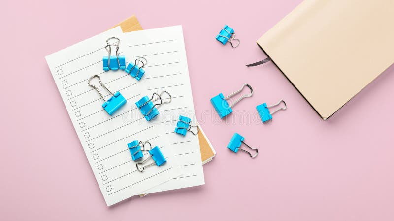 Blue Binder Clips on Checklist Paper with Notebook on Pink Background ...