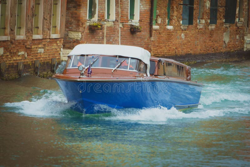 Blue boat in a canal editorial stock image. Image of vacation - 268370799