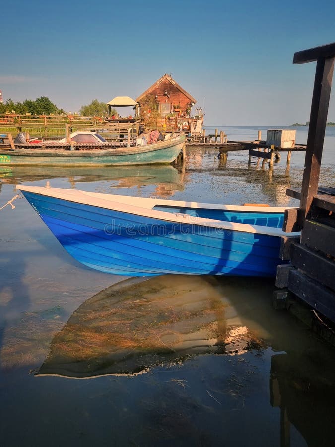 A blue boat with shadow stock image. Image of dock, shore - 227607665