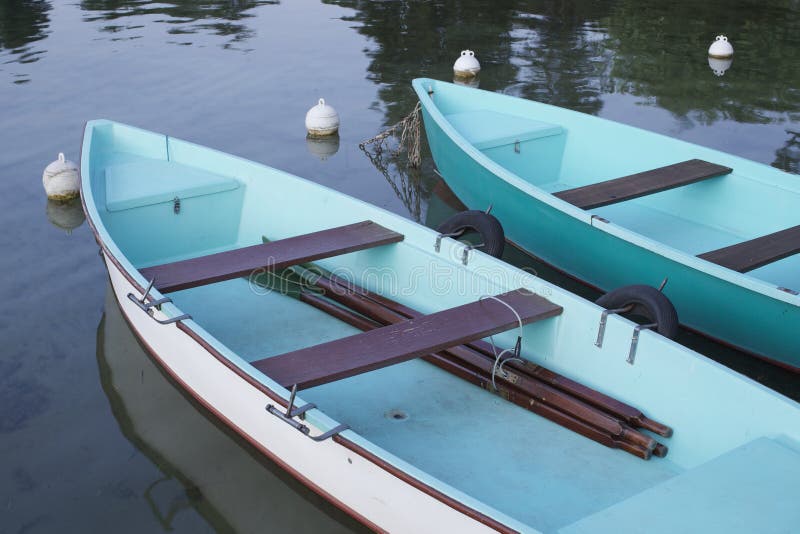 2 Blue Rowing Boats At Border Of Lake Stock Image - Image of reflection ...