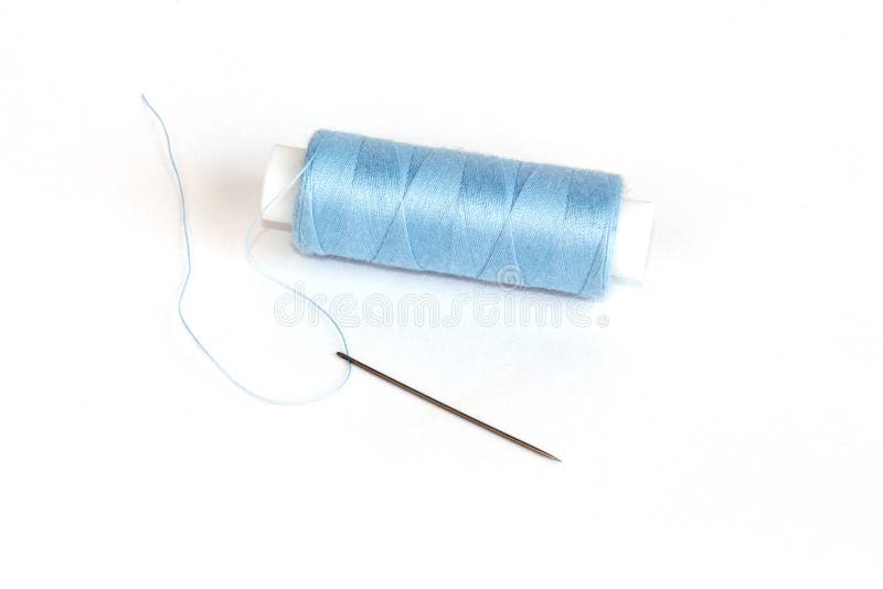 Blue Bobbin of Thread with Needle on White Stock Photo - Image of ...