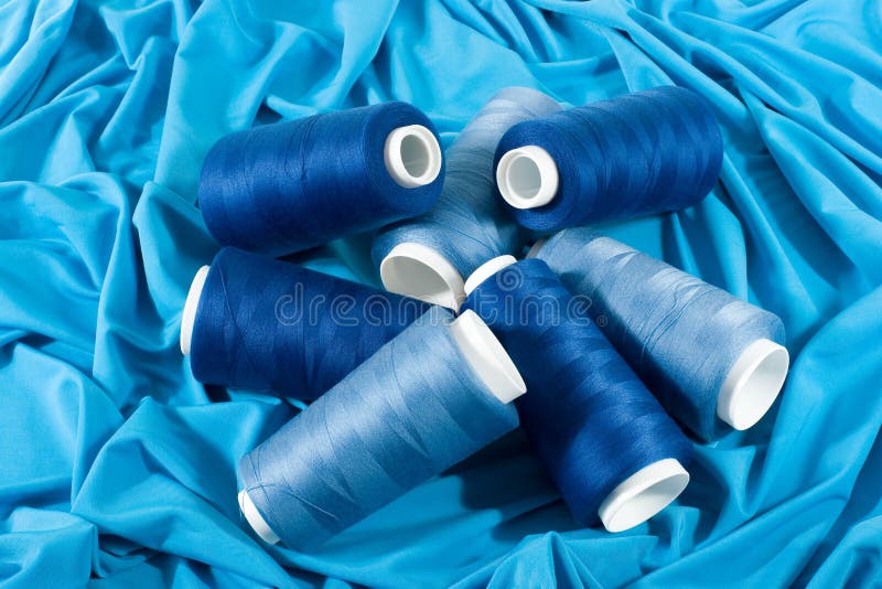 Blue Bobbins of Threads on Blue Cloth Stock Photo - Image of conical ...