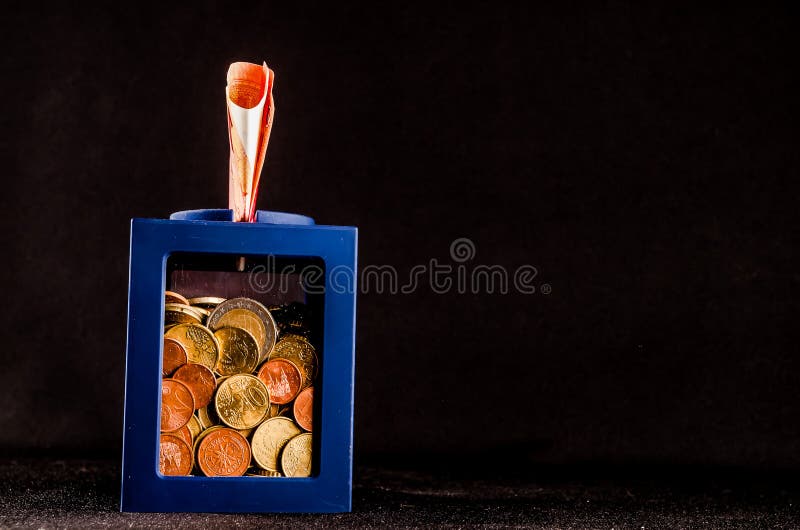 A Blue Box with a Red Ribbon and a Pile of Coins Inside Stock Photo ...