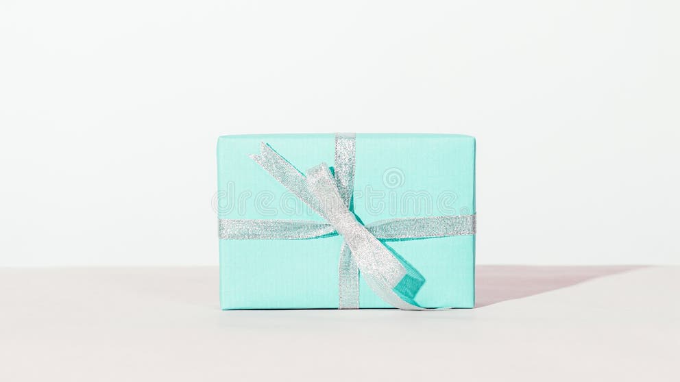 Blue Box with a Silver Ribbon on a Table Stock Photo - Image of tied ...