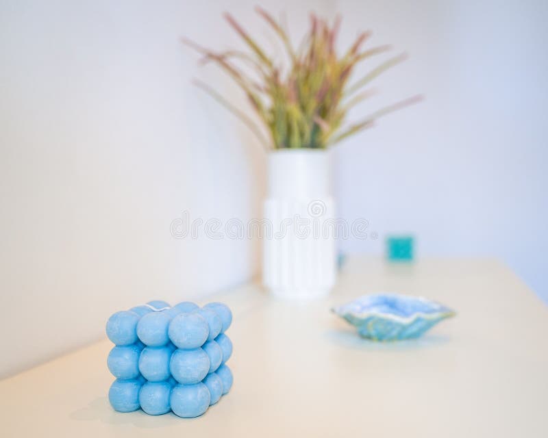 Blue Bubble Cube Candle with a Plant in a Vase in the Blurry Background ...