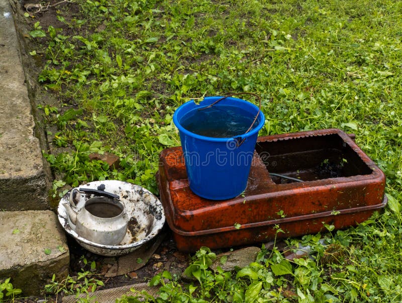A Blue Bucket Sitting on Top of a Metal Box in the Grass Stock Image ...