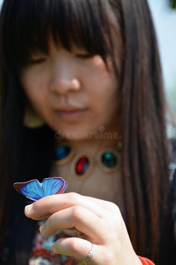 Girl Holding Blue Butterfly on Her Hand Stock Photo - Image of blue ...
