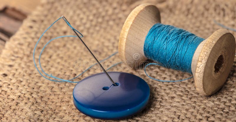 Blue button with needle stock image. Image of tailor - 117541115