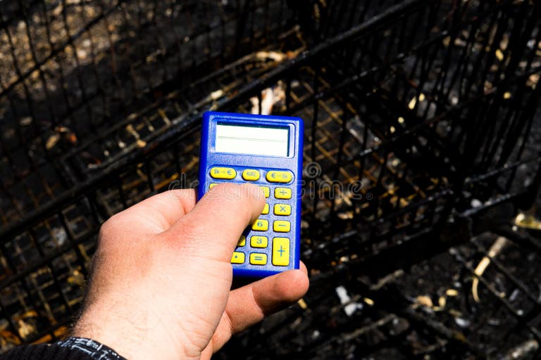 Blue Calculator in Dark Soil, Burnt Ground after the Fire Stock Image ...