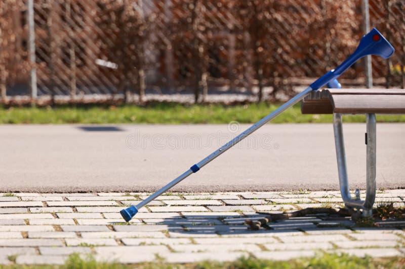 A Blue Cane is Leaning Against a Bench Stock Photo - Image of care ...