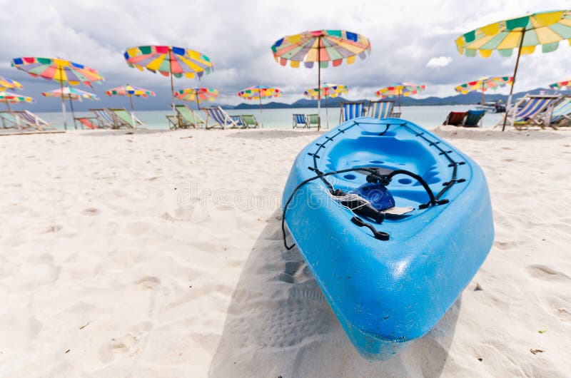 Blue Canoe with Colorful Beachbeds Stock Photo - Image of holidays ...