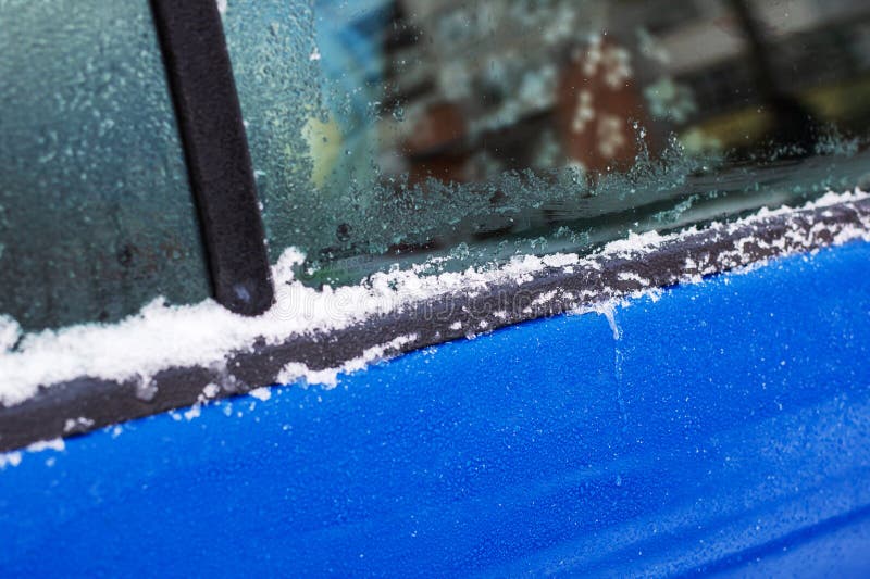 A Blue Car Covered with Snow on the Side of it during Winter Stock ...