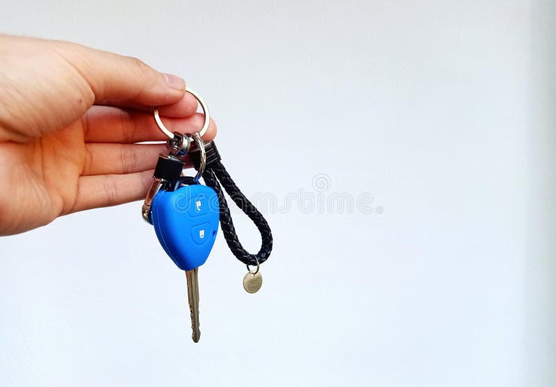 A Blue Car Key in the Hand with a White Background Stock Photo - Image ...