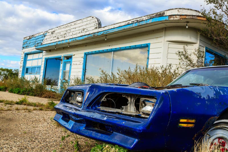 A Blue Car is Parked in Front of a White Building Stock Image - Image ...