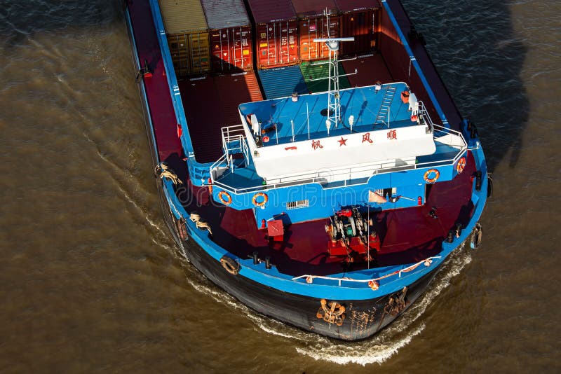 Blue Cargo Ship Navigating through the Brown Waters of the Yangtze ...