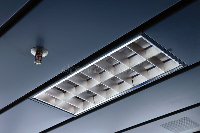 A Blue Ceiling with Light and Fire Sprinkler Stock Photo - Image of ...