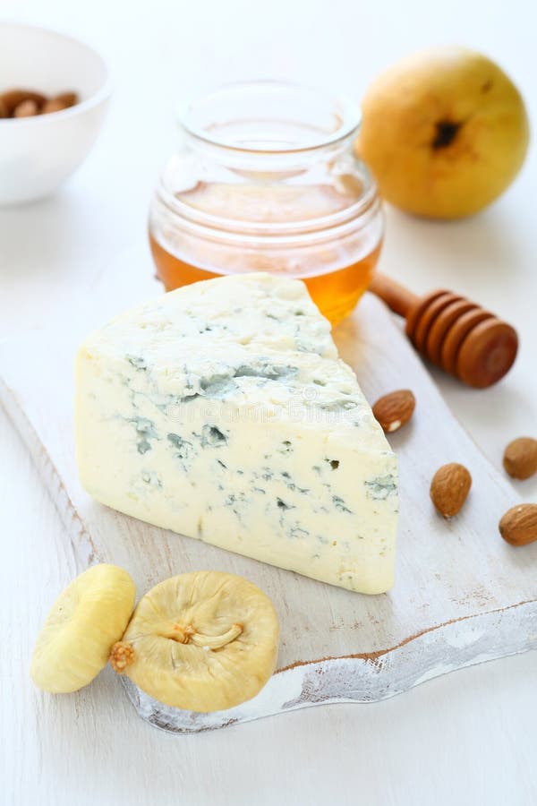 Blue Cheese with Almonds, Figs and Honey on a Cutting Board Stock Image ...