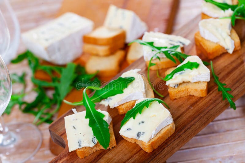 Blue Cheese Served with Toast and Arugula Stock Photo - Image of ...