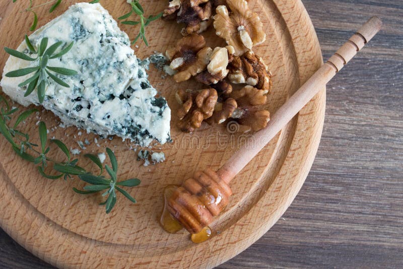 Blue Cheese on a Wooden Serving Board with Walnuts and Honey Stock ...
