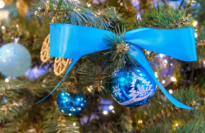 Blue Christmas Ball with a Blue Satin Ribbon on the Christmas Tree ...