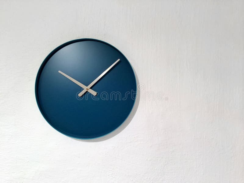 Blue clock on white wall stock image. Image of modern - 46313579