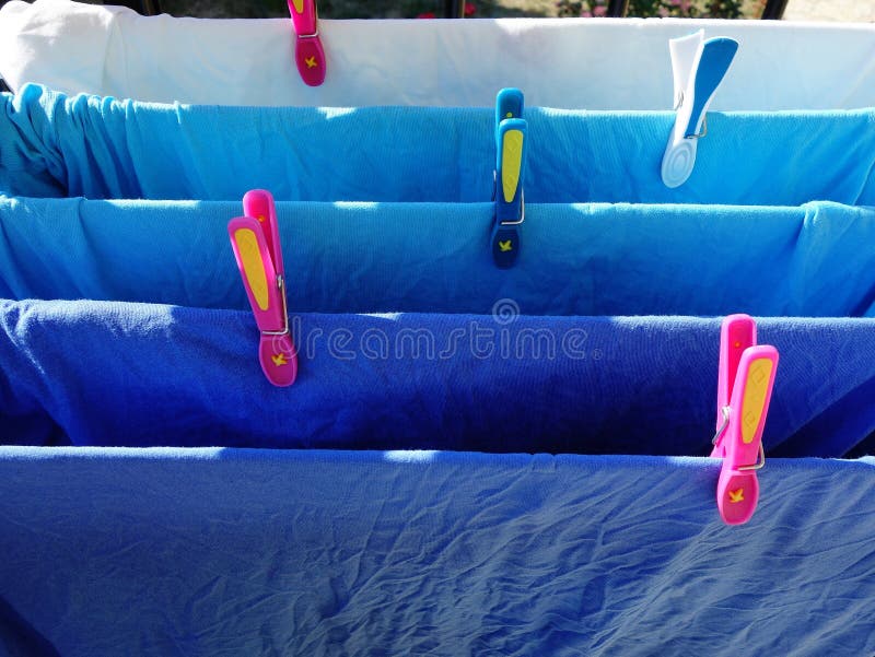 Blue Clothes on Drying Rack Stock Photo - Image of clothes, pegs: 55758616