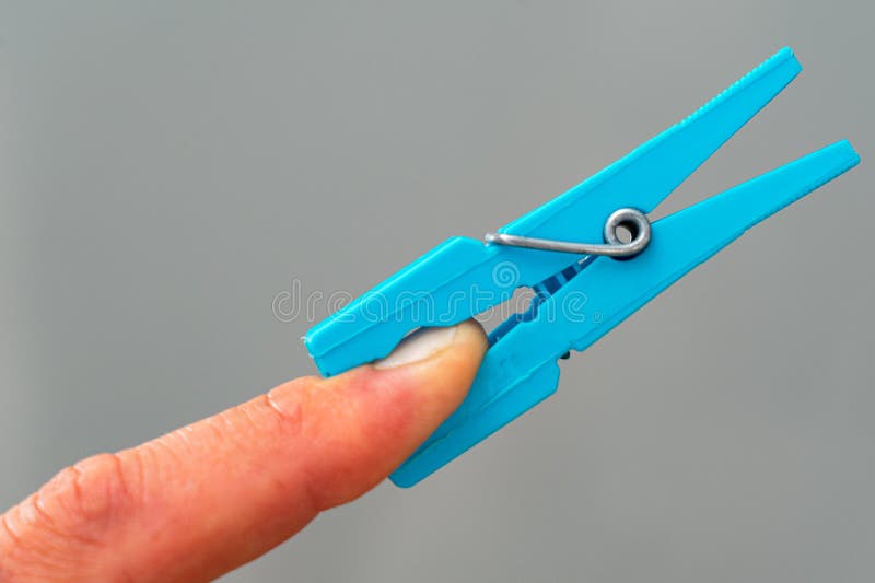 Blue Clothes Peg Pinching Index Finger Stock Image - Image of blue ...