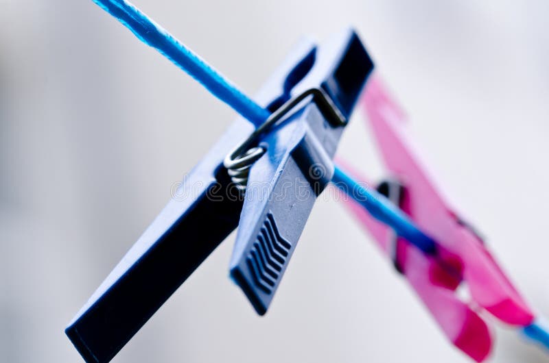 A Blue Clothing Line with Many Raindrops at the String in Front of a ...