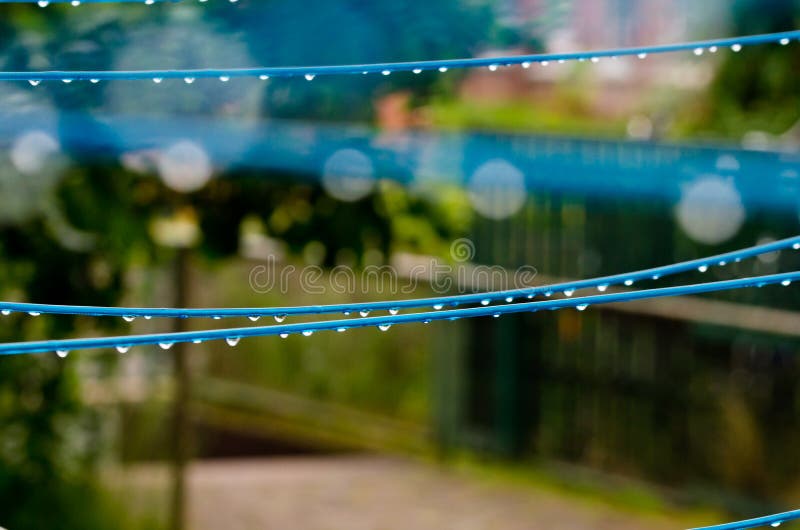 Blue Clothing Lines of a Clothes Spin with Many Raindrops at the String ...