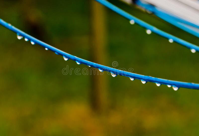 Blue Clothing Lines of a Clothes Spin with Many Raindrops at the String ...