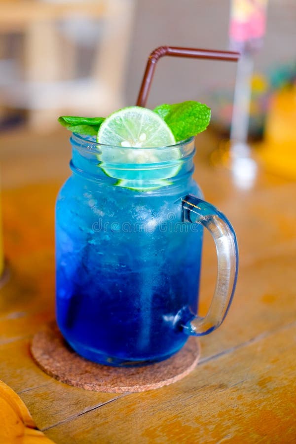Blue Coctail with Lemon and Ice Cubes Stock Image - Image of liquor ...