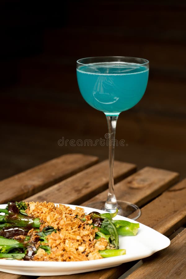 Blue Coctail and a Meal on Wodden Table Stock Photo - Image of fruit ...