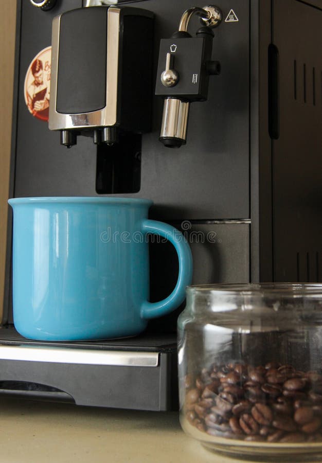 Blue Coffee Mug and Coffee Machine Standing in the Kitchen ...