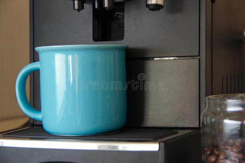 Blue Coffee Mug and Coffee Machine Standing in the Kitchen ...