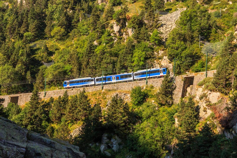 Blue Cogwheel Train Going Up in Wooded Mountain Stock Photo - Image of ...