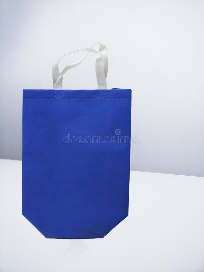 Blue Color Bag with White Handle, Eco Friendly Bag on White Table Stock ...