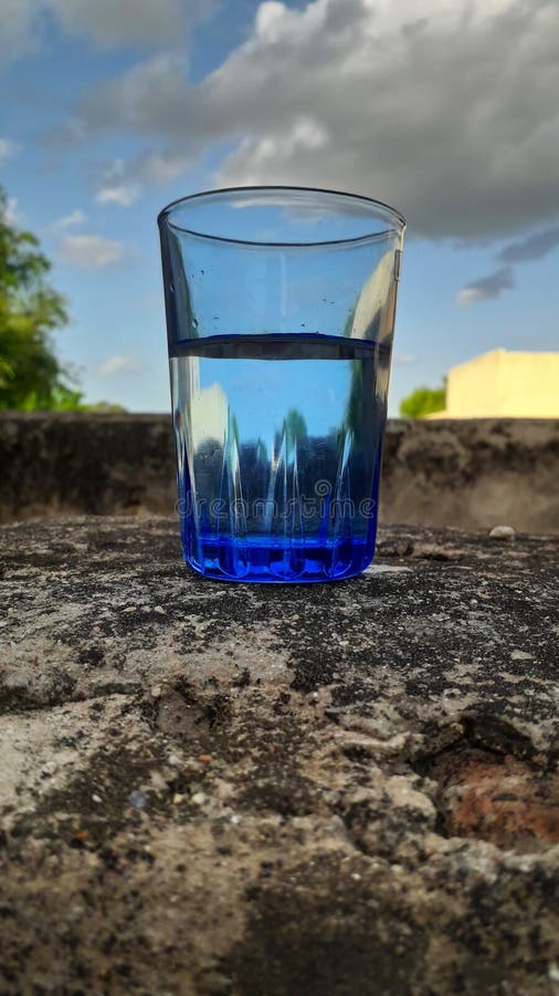 Blue Color Glass Half Filled with Water Vertical Photo Stock Photo ...