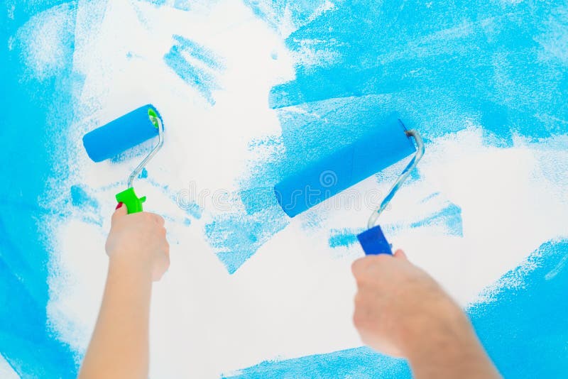 Blue Color Painting Wall with Roller in Hand. Stock Photo - Image of ...