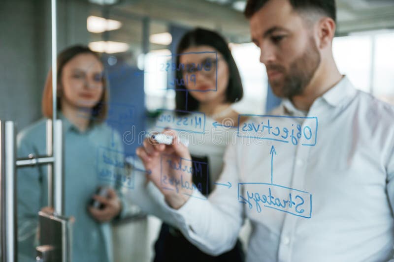 Blue Color Text. Office Workers are Creating Plan, Standing by Glass ...